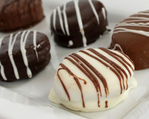 Chocolate Dipped Alfajor Cookies - Azucar Bakery